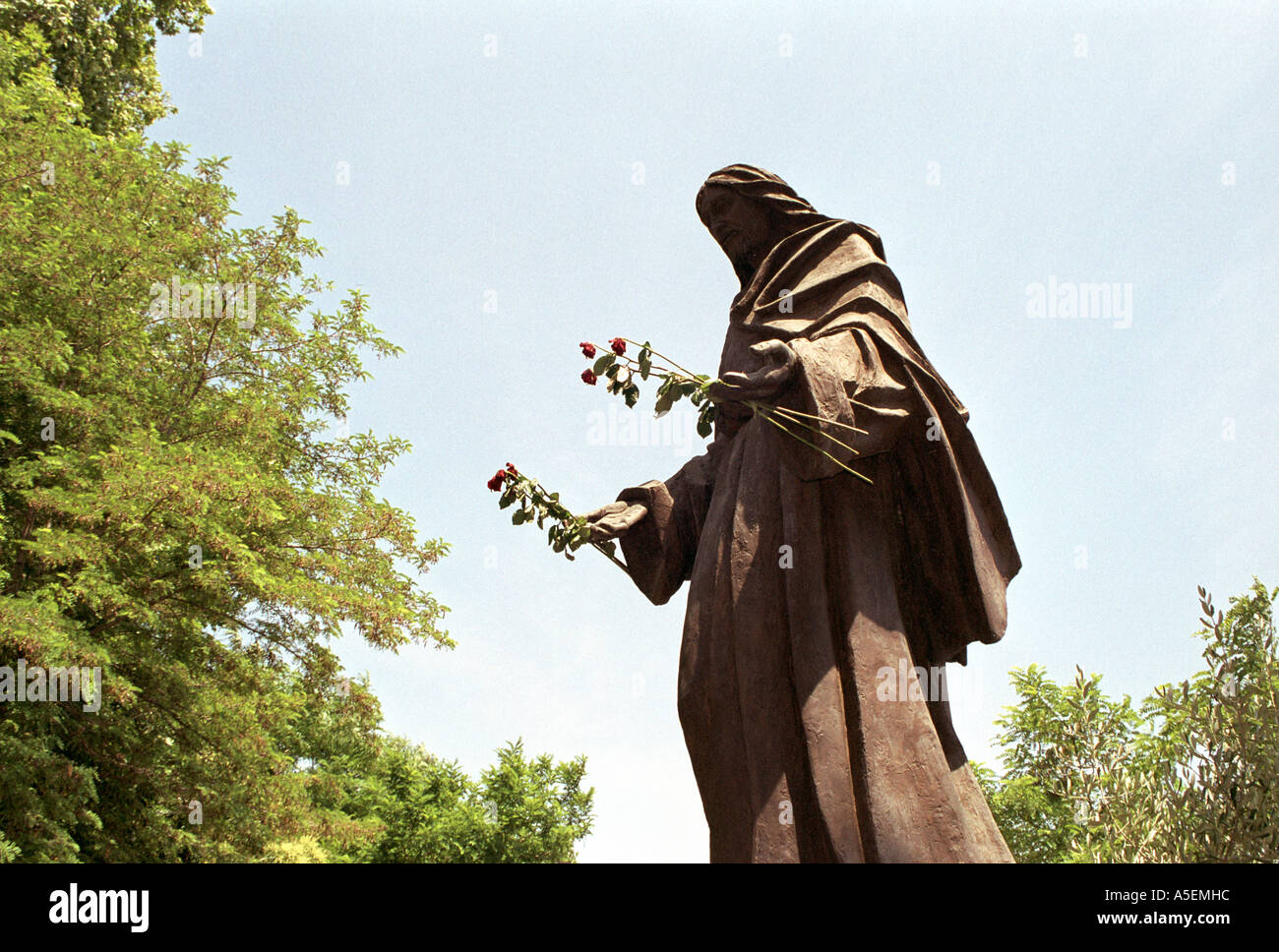 jesus statue holding roses in rome Stock Photo - Alamy