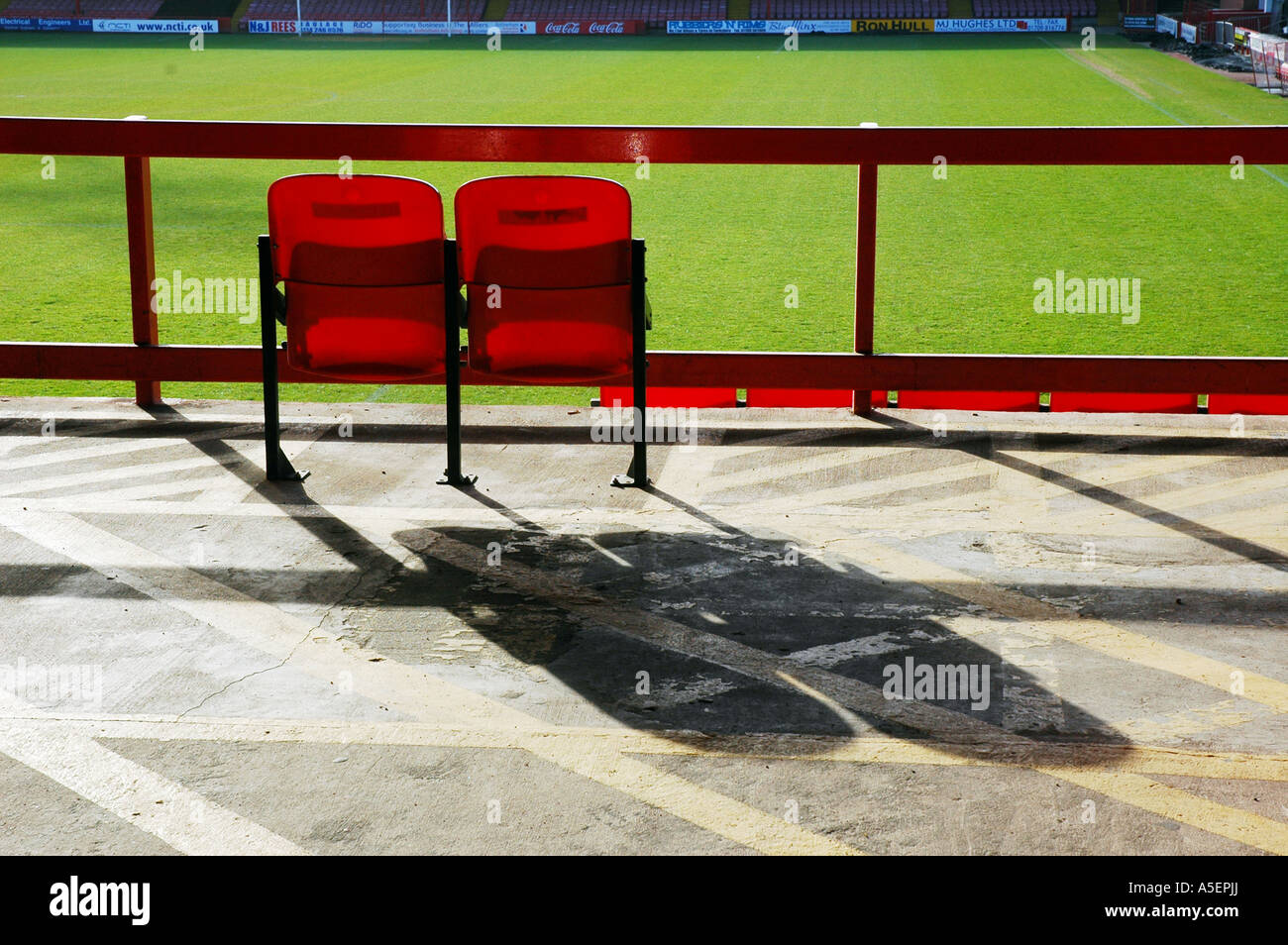 Pair of red spectator seats on the terrace of Rotherham United, a ...