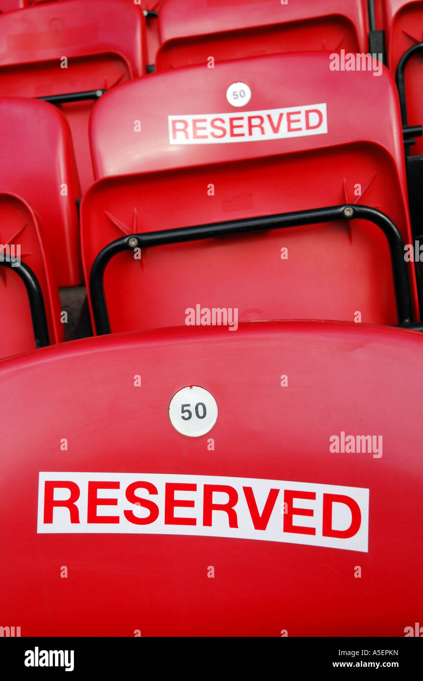 Red plastic seats marked Reserved at a British football club stadium ...
