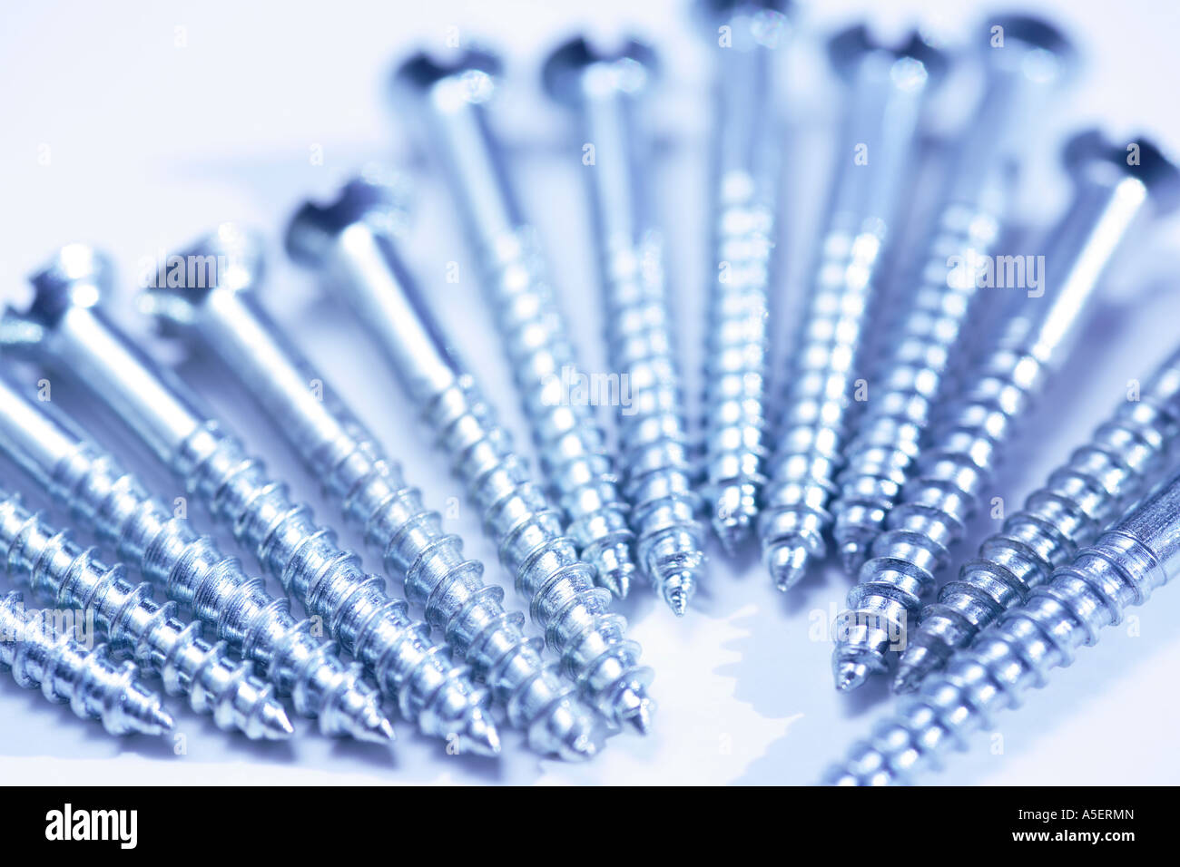 Silver screws against white background horizontal Stock Photo - Alamy
