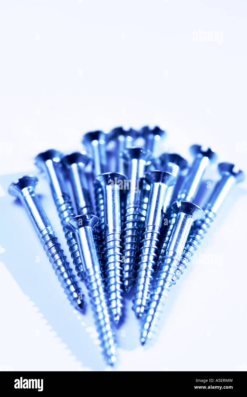 Silver screws against white background vertical Stock Photo - Alamy