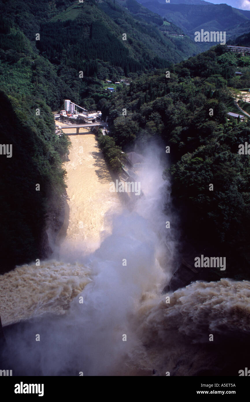 Two massive gates open on a Japaneses dame to release the flood waters ...