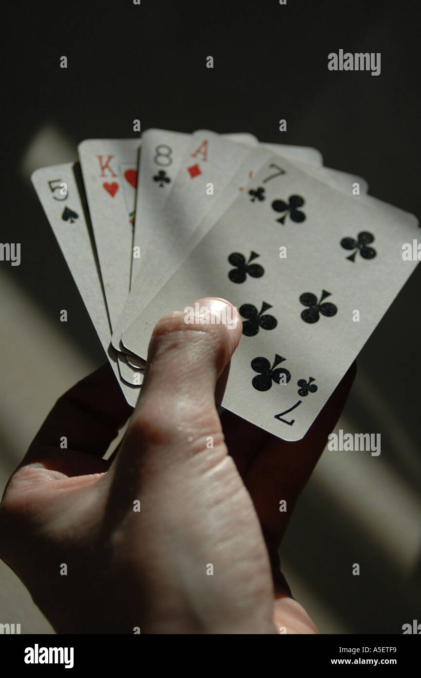 playing cards held in hand Stock Photo - Alamy