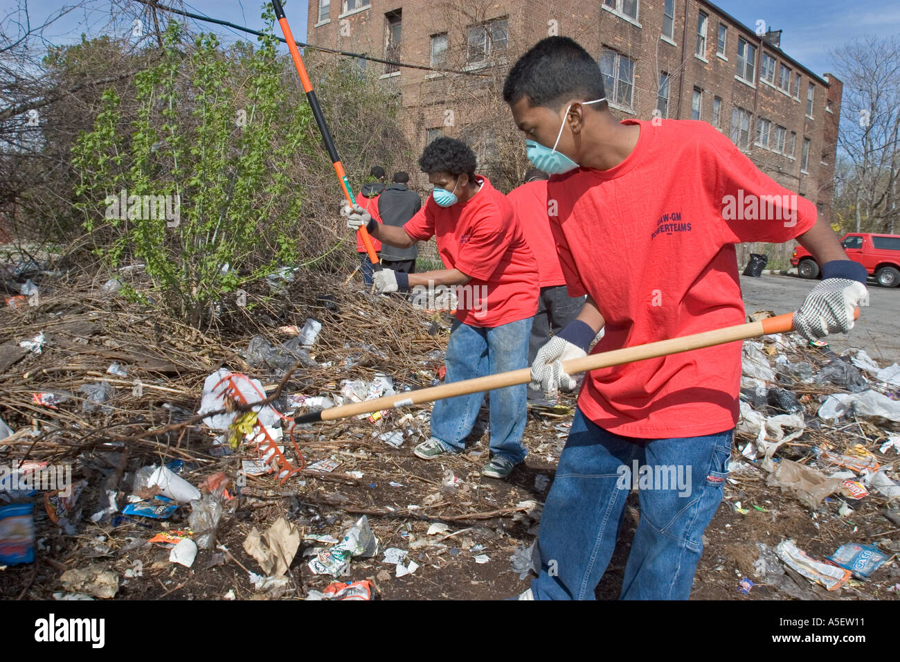 High School Volunteers Clean Grounds of Homeless Shelter Stock Photo ...