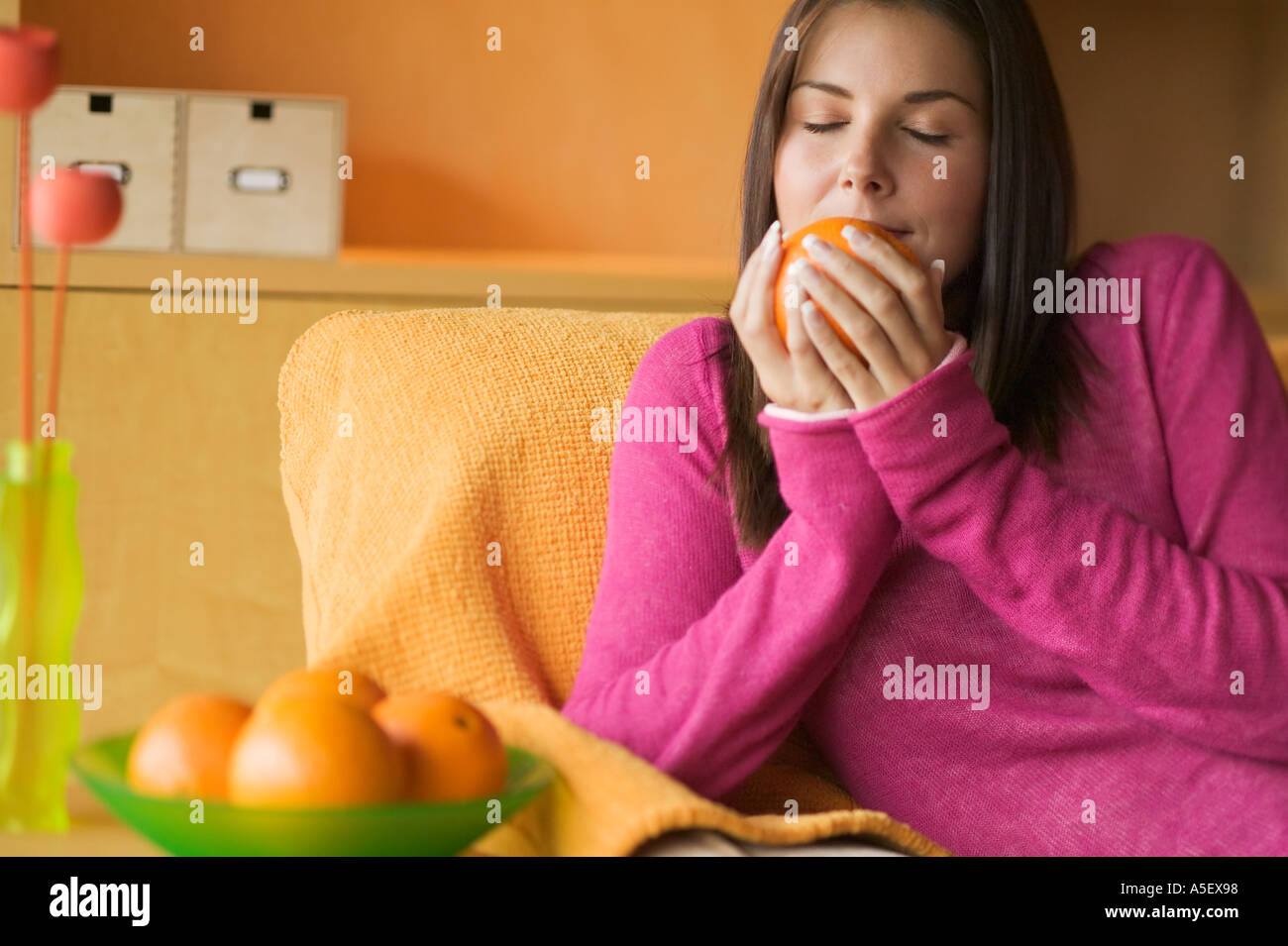 Woman smelling orange fruit hi-res stock photography and images - Alamy