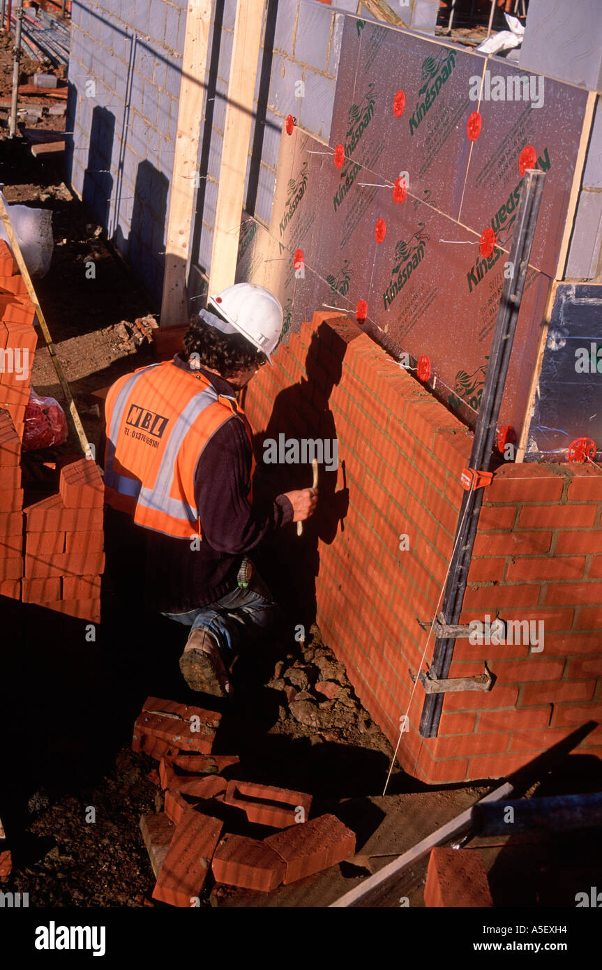 Bricklayers building a new wall on a building site Stock Photo - Alamy