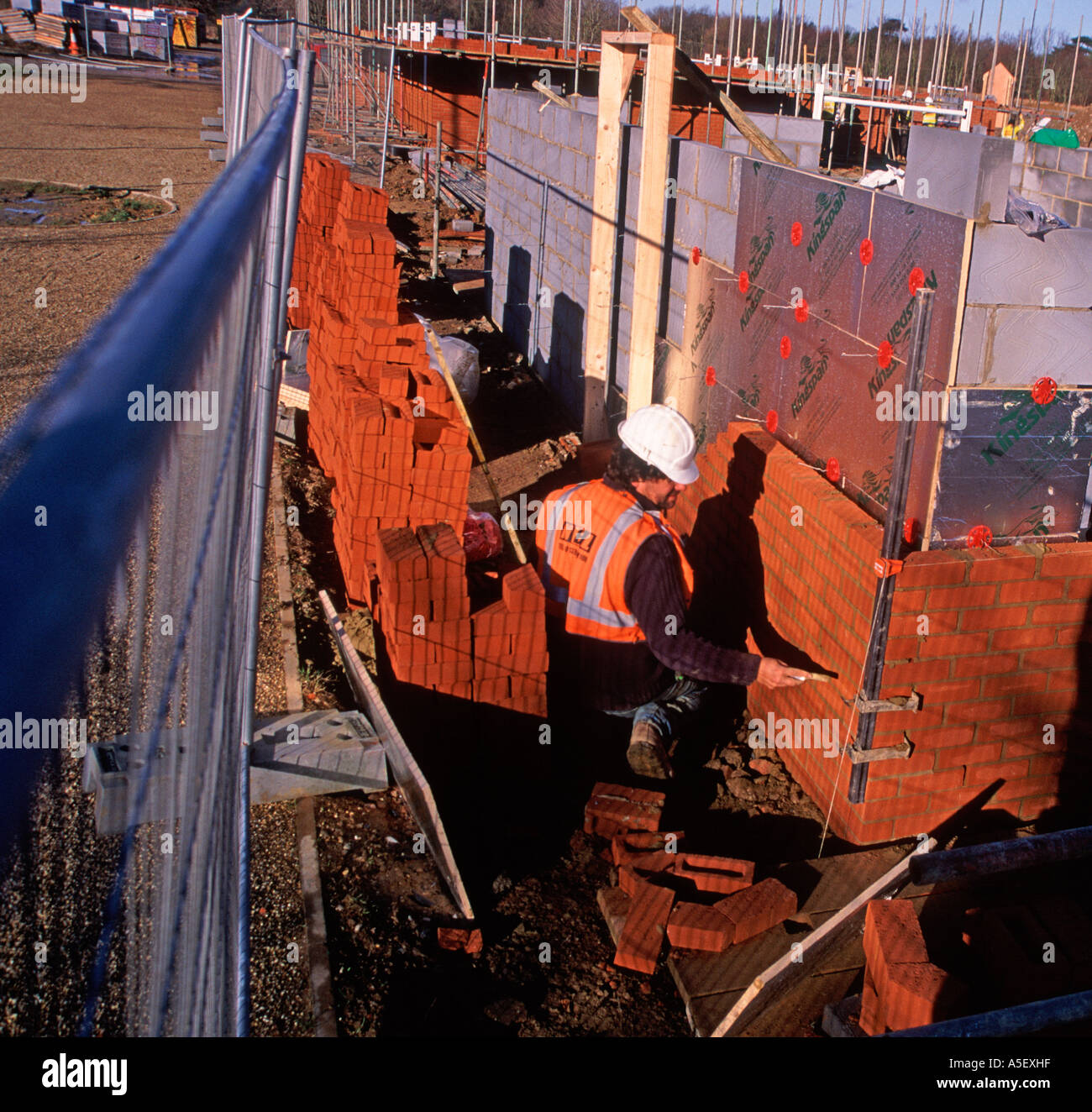 Bricklayers building a new wall on a building site Stock Photo - Alamy