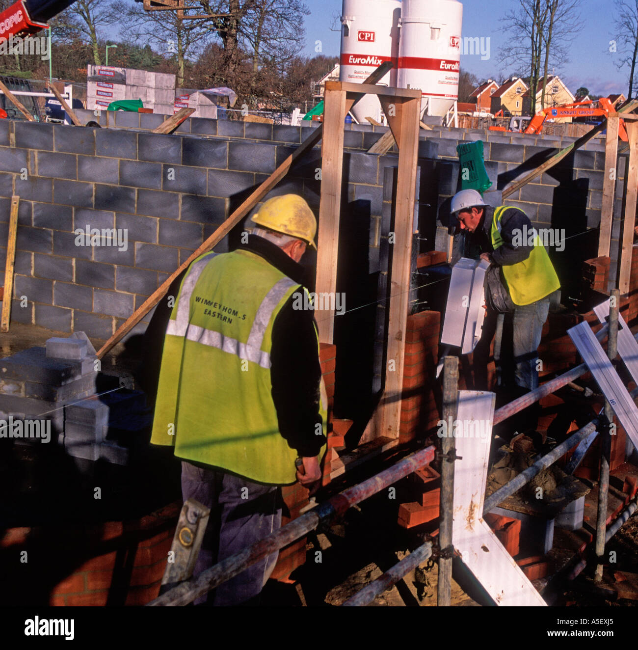 Bricklayers building a new wall on a building site Stock Photo - Alamy