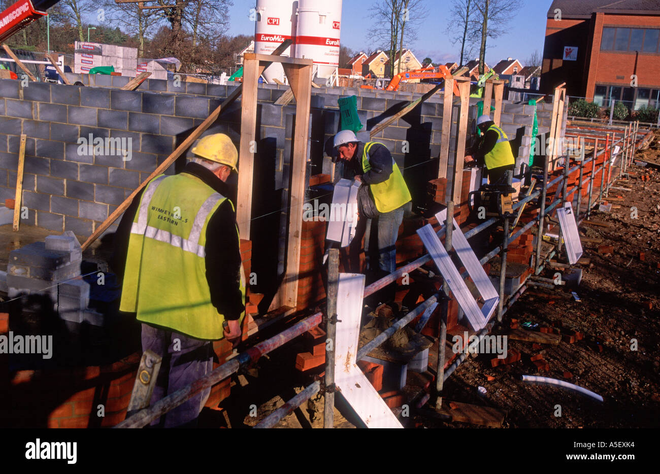 Bricklayers building a new wall on a building site Stock Photo - Alamy