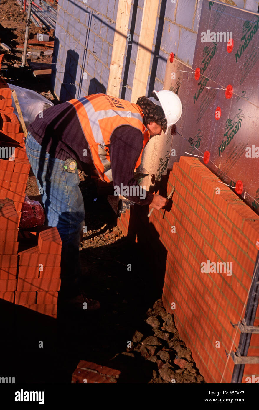 Bricklayers building a new wall on a building site Stock Photo - Alamy