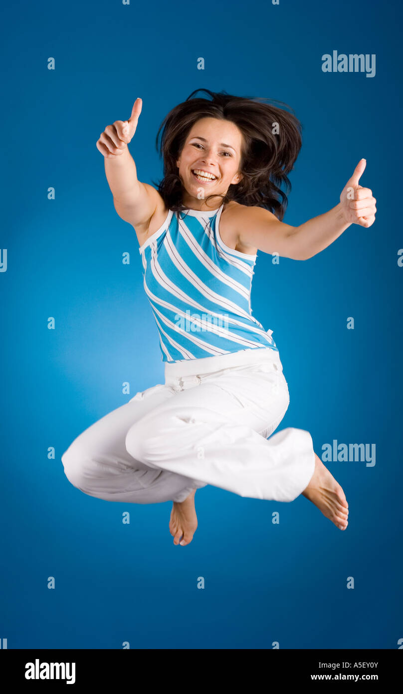 jumping happy woman on the blue background Stock Photo - Alamy