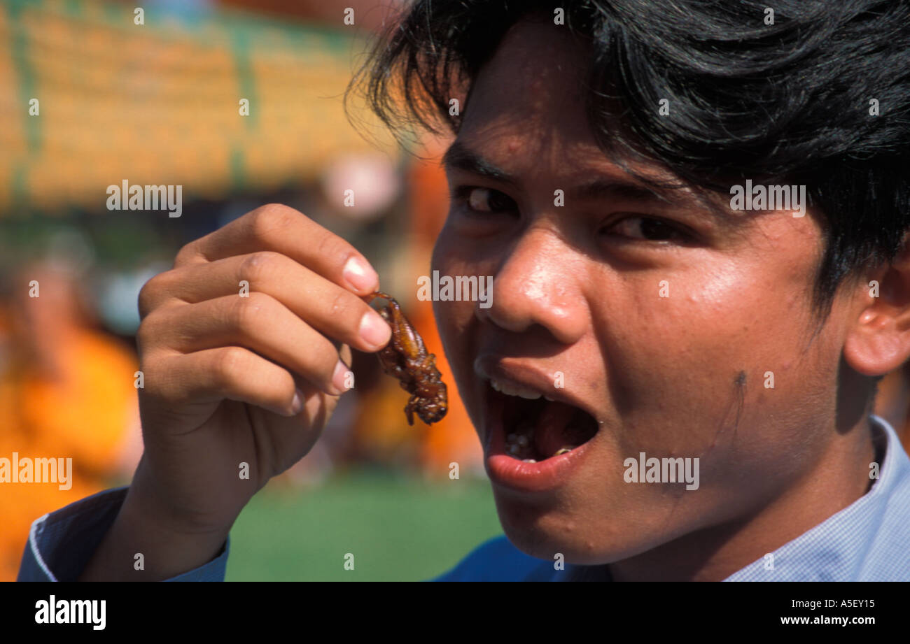 Khmer man eating a Locust Phnom Penh, Cambodia - Asia Stock Photo - Alamy