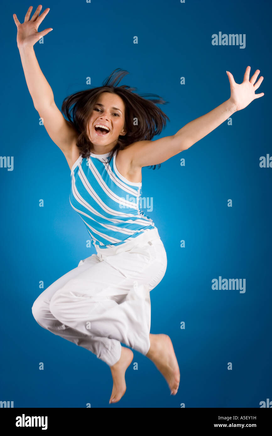 jumping happy woman on the blue background Stock Photo - Alamy