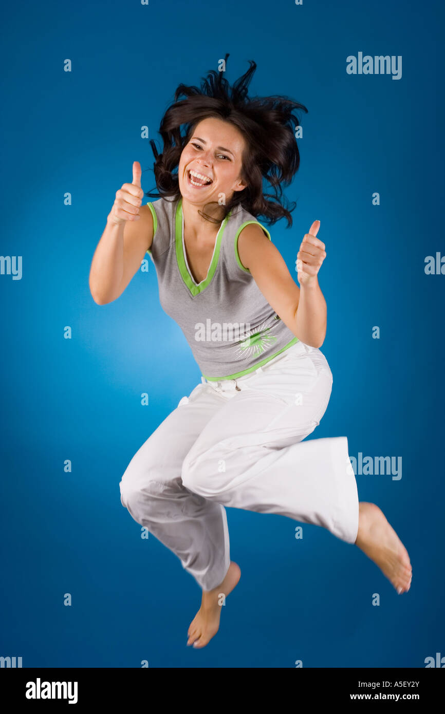 jumping happy woman on the blue background Stock Photo - Alamy