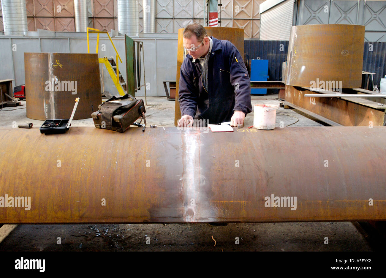 Engineer inspecting weld on part of a steel foot and cycle bridge to ...