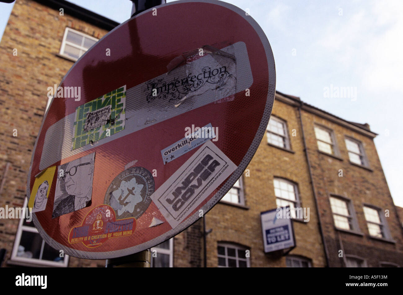 A No Entry sign in London vandalized by stickers Stock Photo - Alamy
