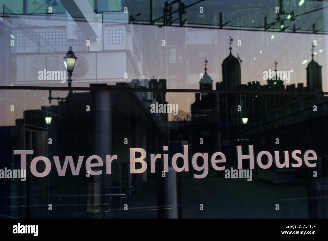 Silhouetted city skyline reflected in window of Tower Bridge House at ...
