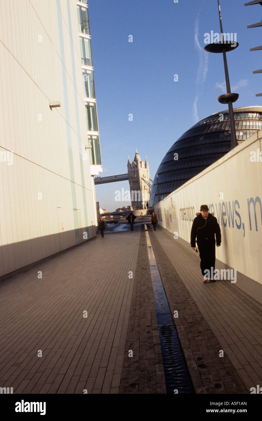 A walkway in London with the Tower Bridge visible in the background ...
