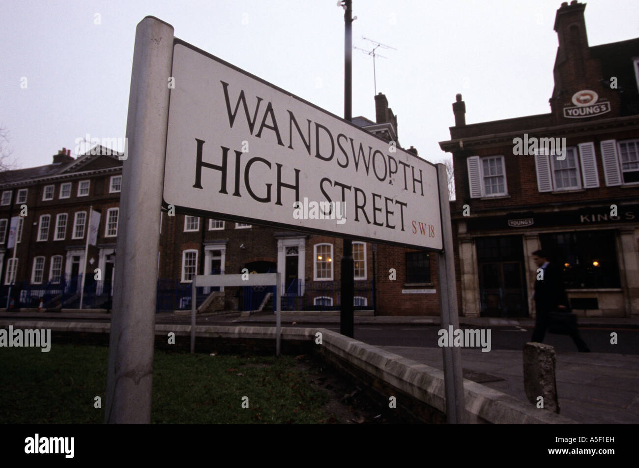A road sign indicating Wandsworth and High Street area of London Stock ...