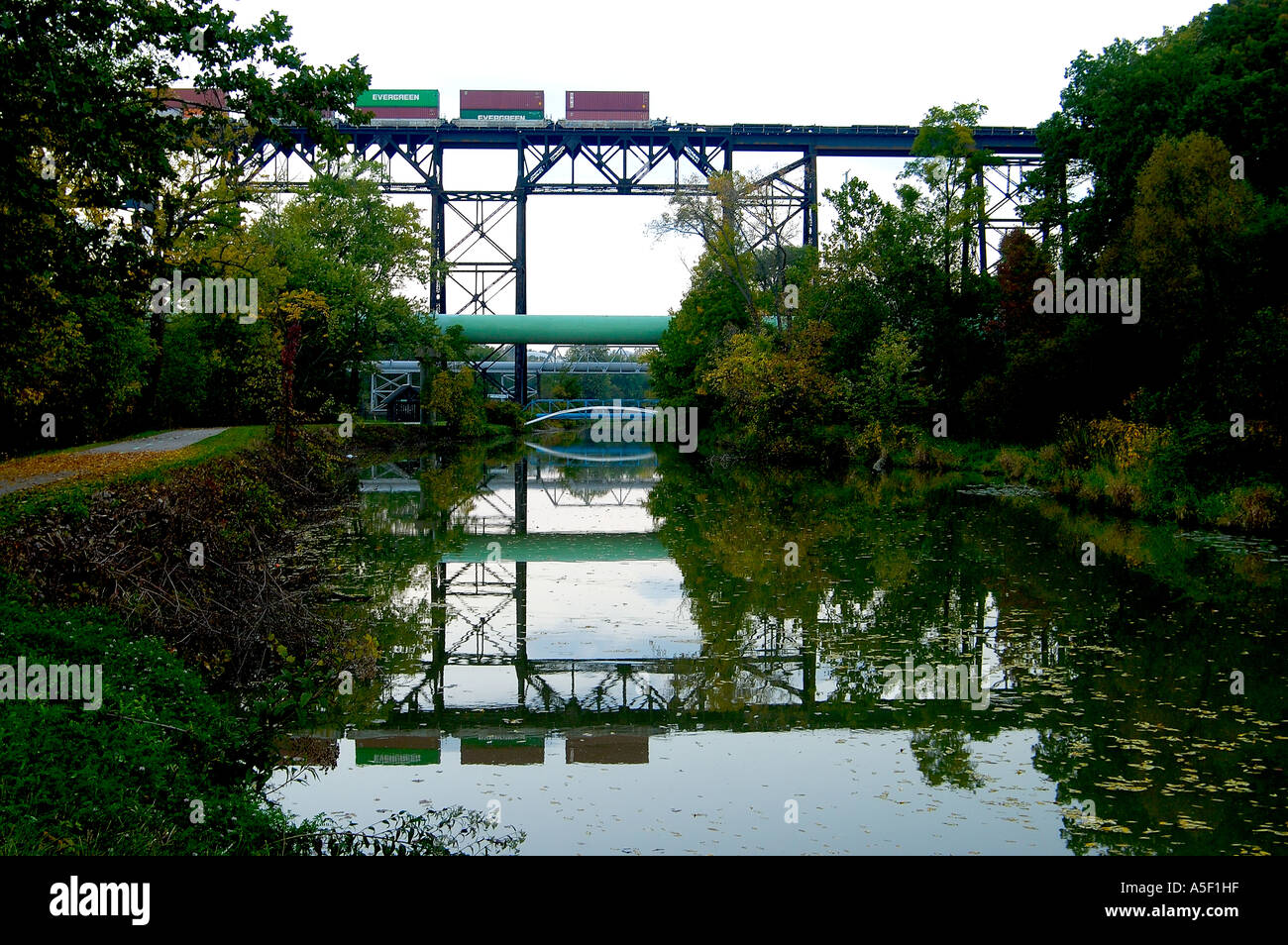 train on tressle truss structure bridge with oil pipeline below and all ...