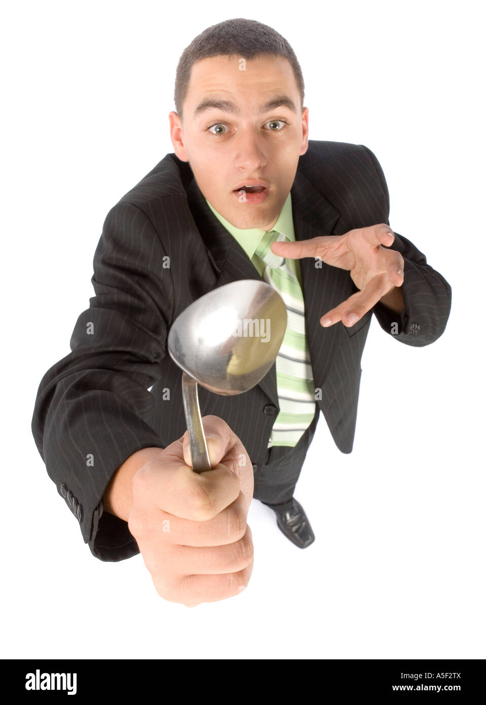 isolated on white businessman bending spoon by mind force Stock Photo ...