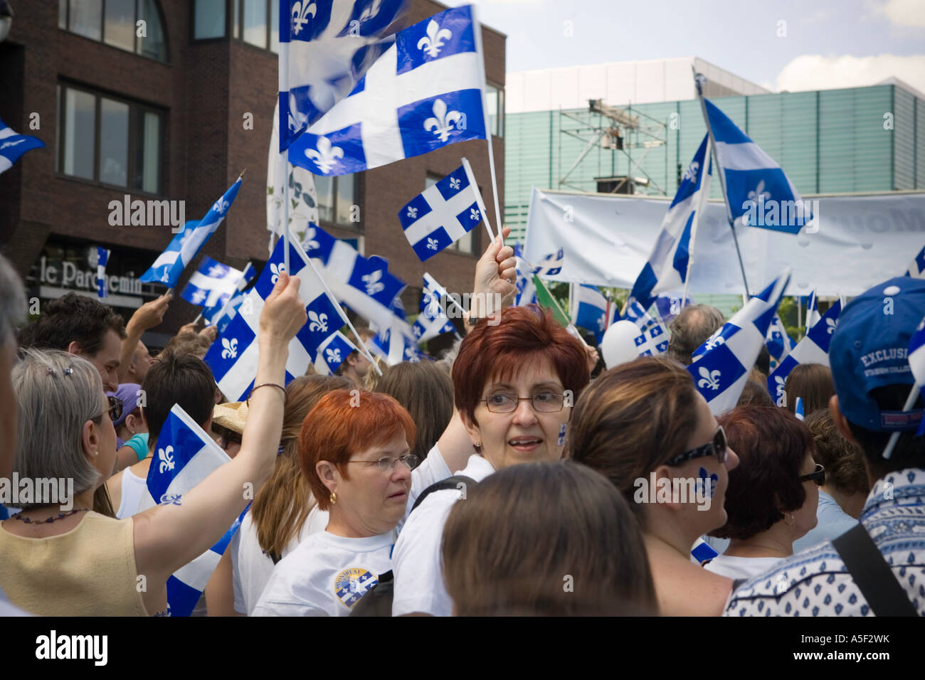 People on the street carrying Quebec's provincial flag during the Jean ...