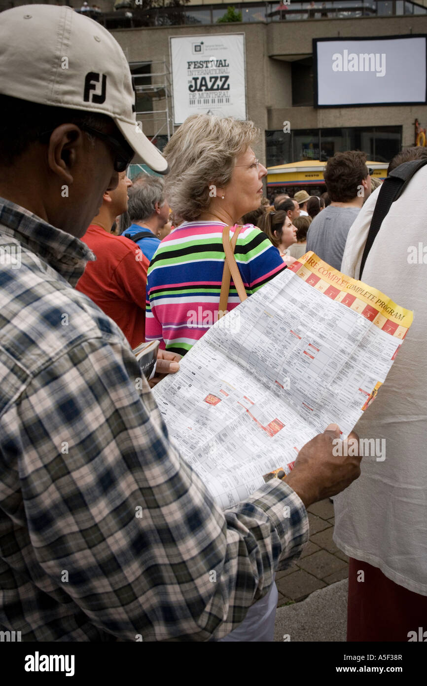 Jazz fan goes over the event program at the Montreal Jazz Festival ...