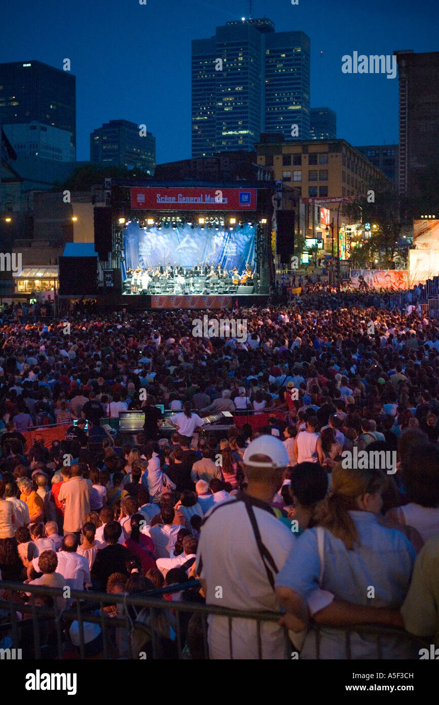 Crowds attending an evening performance at an outdoor music festival in ...