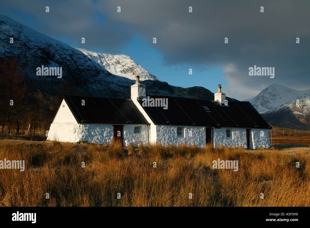 Black Rock Cottage, with with snow capped Buachaille Etive Mor ...