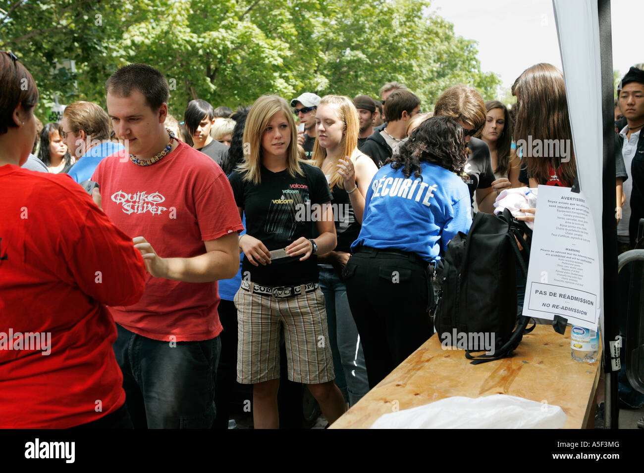 Young teenage fans passing through a security check at an outdoor ...