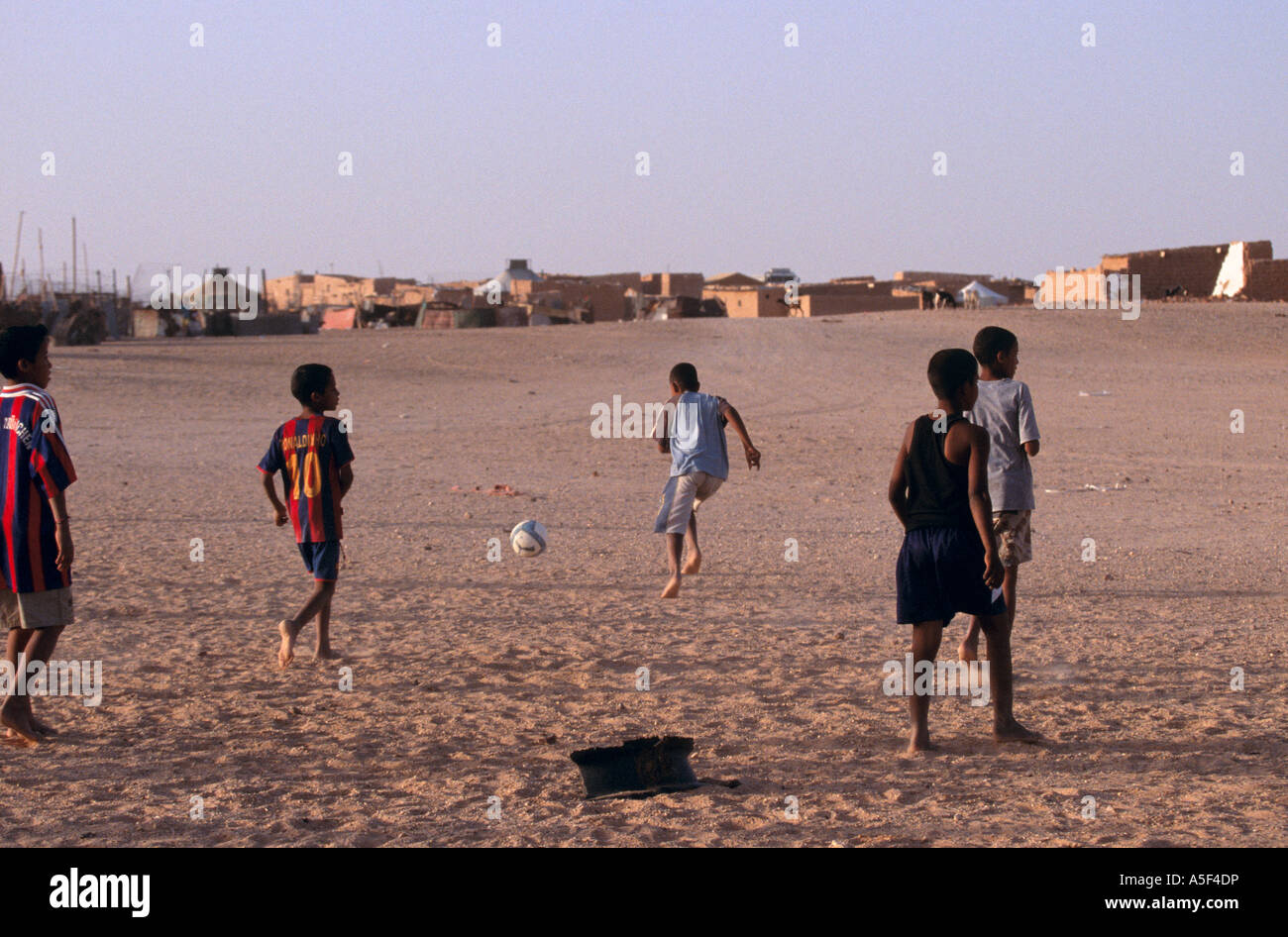Children from Saharawi refugee camp playing football in the evening ...