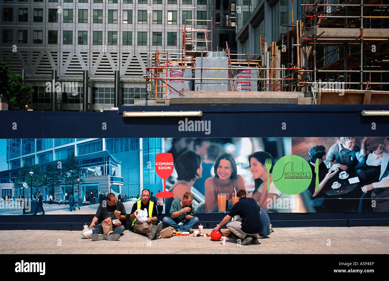 Construction workers taking their lunch break at Canary Wharf London ...