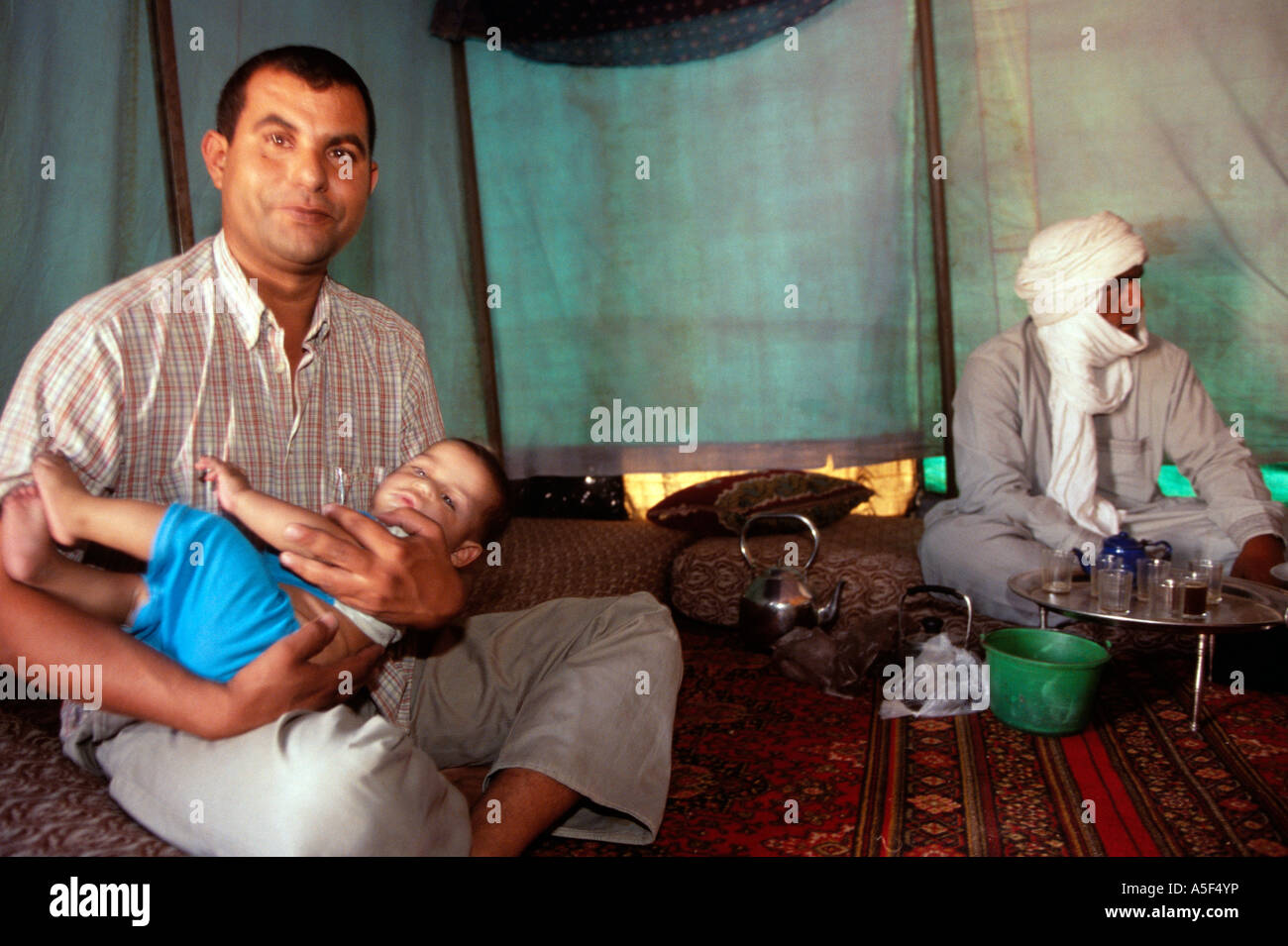 A Saharawi refugee and his baby in their home in Tindouf Western ...