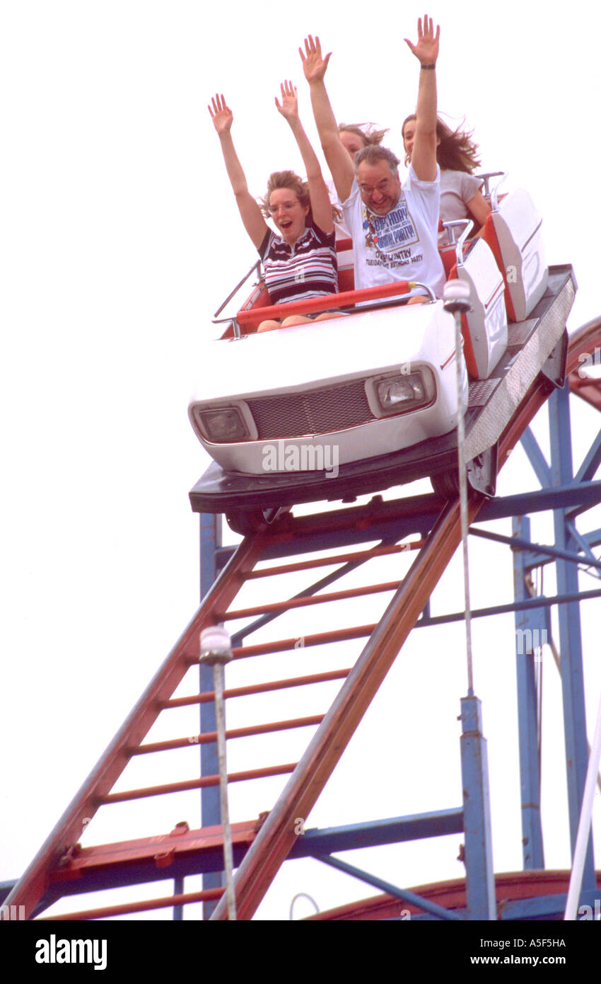 Family riding roller coaster at state fair with arms up age parents 40 ...