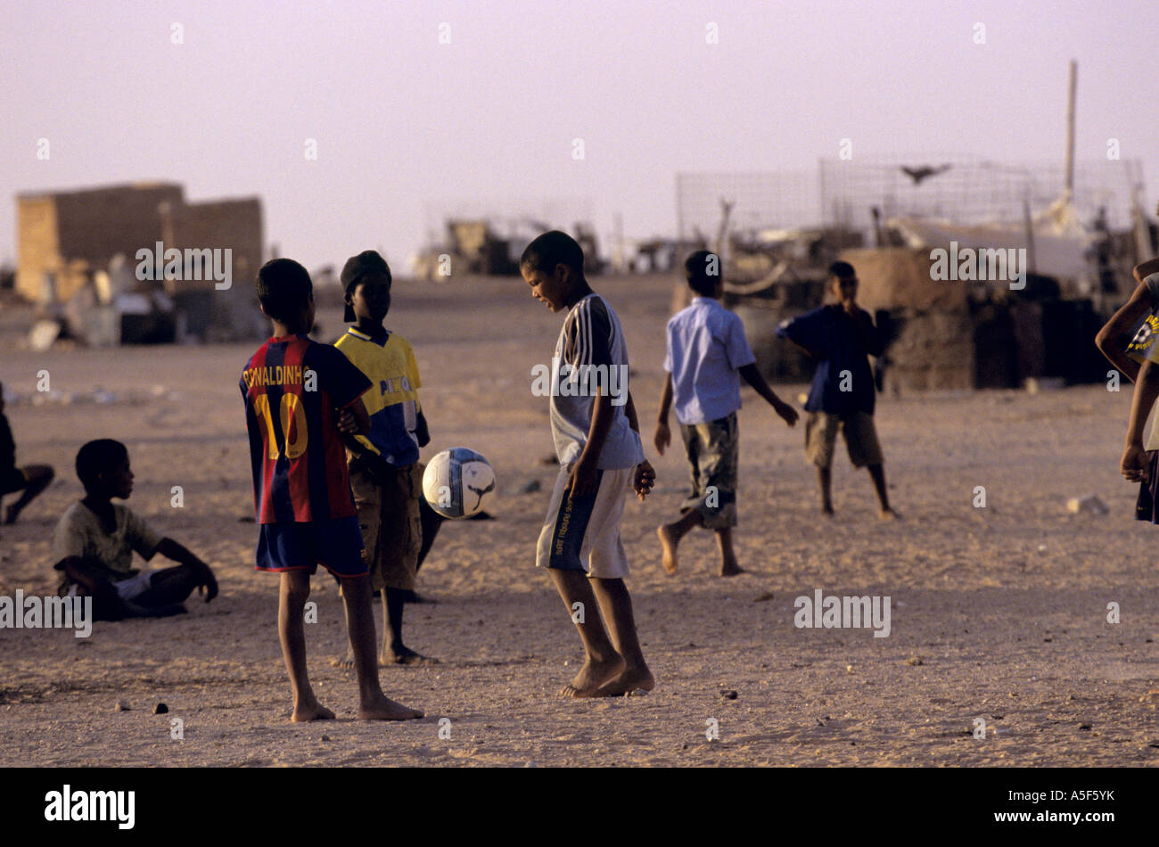 Boys playing soccer barefoot hi-res stock photography and images - Alamy