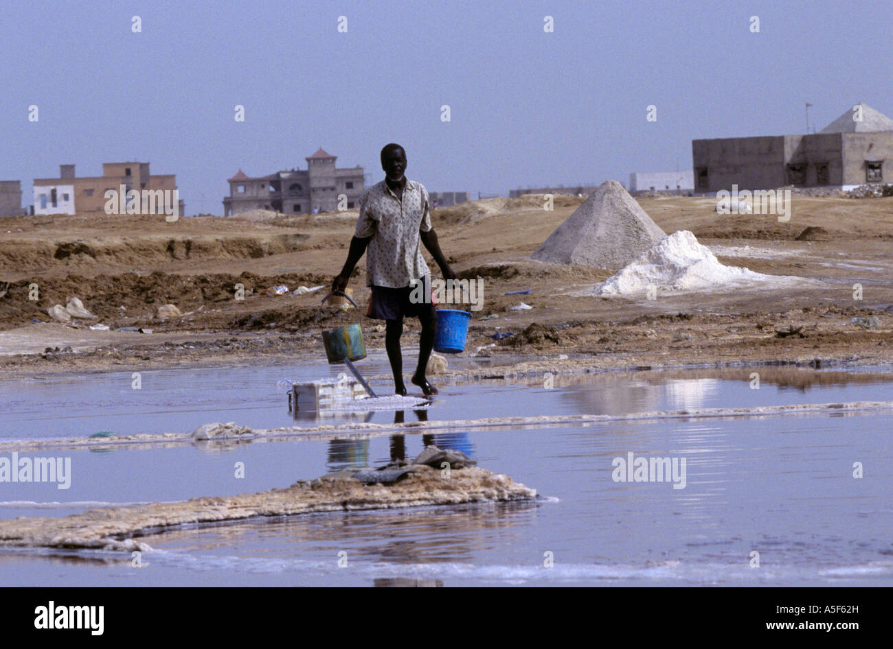 Salt farmer working in the salt farm in Nouakchott, Mauritania, Africa ...