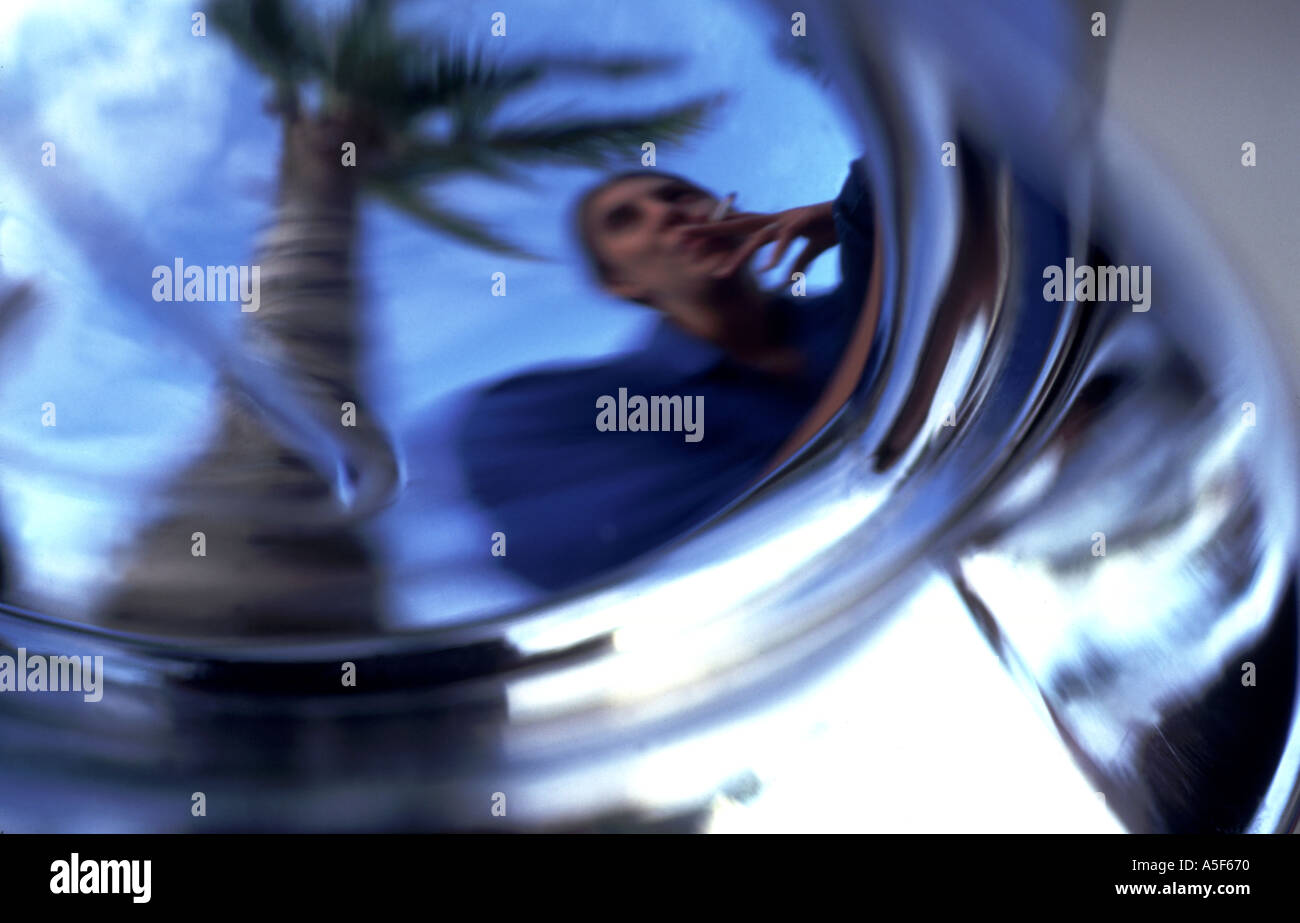 reflection of palm tree and woman smoking, Mauritius Stock Photo - Alamy