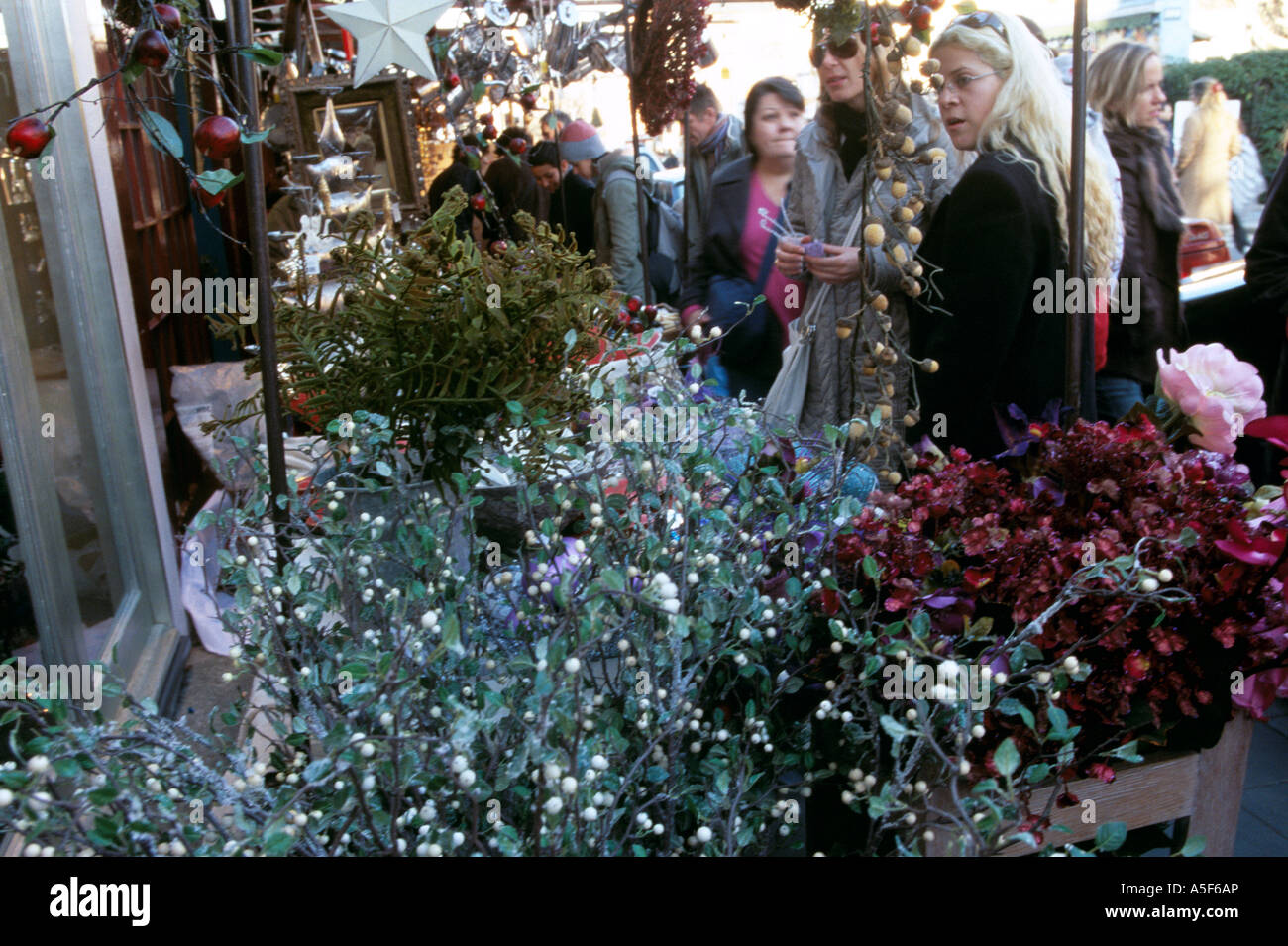 Shoppers looking at a display outside a shop window in London Stock ...
