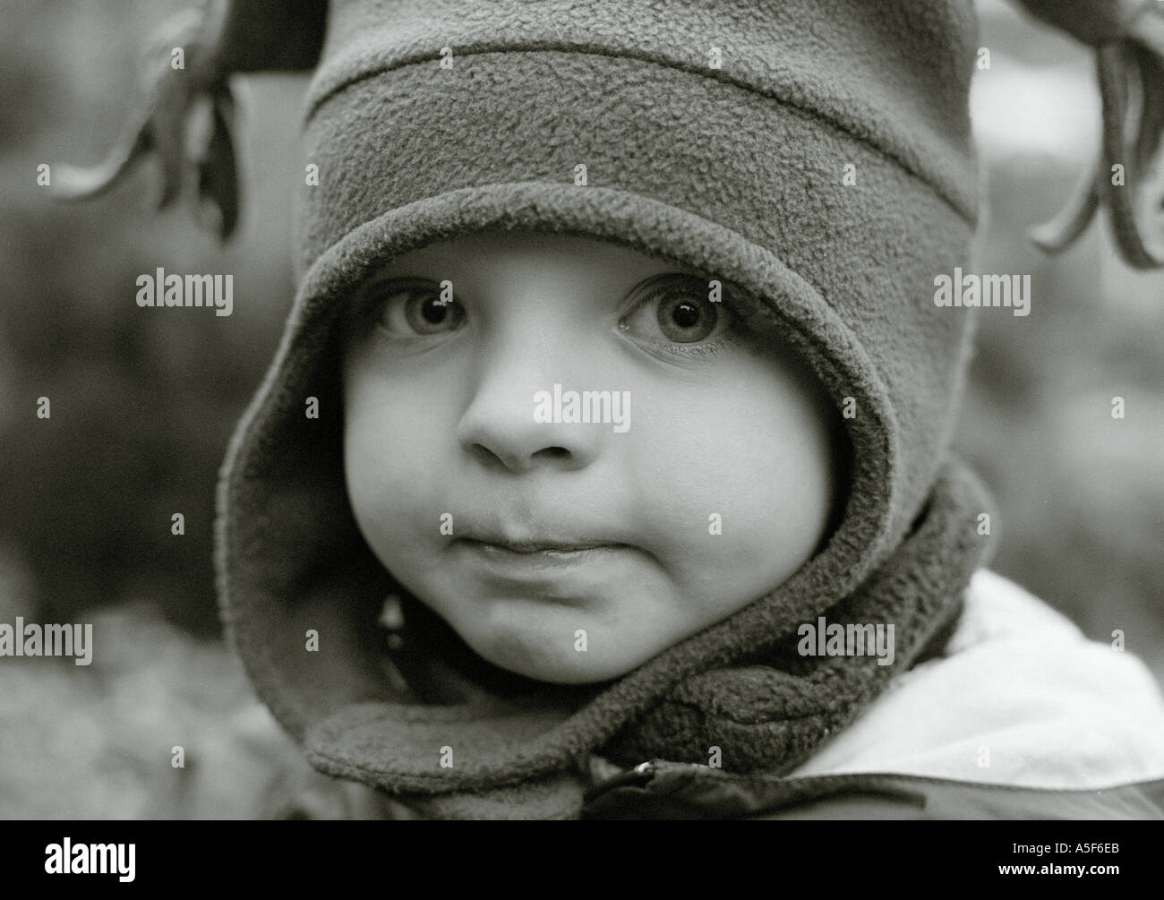 small pensive boy wearing a big funny hat Stock Photo - Alamy