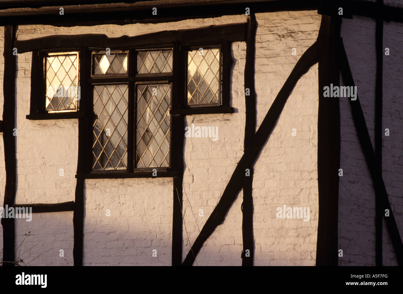 Detail of timber framed Tudor house with leaded casement windows in ...
