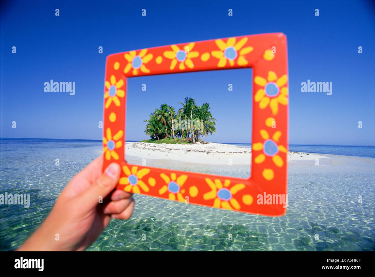 Hand holding frame showing small tropical island in Belize Central ...