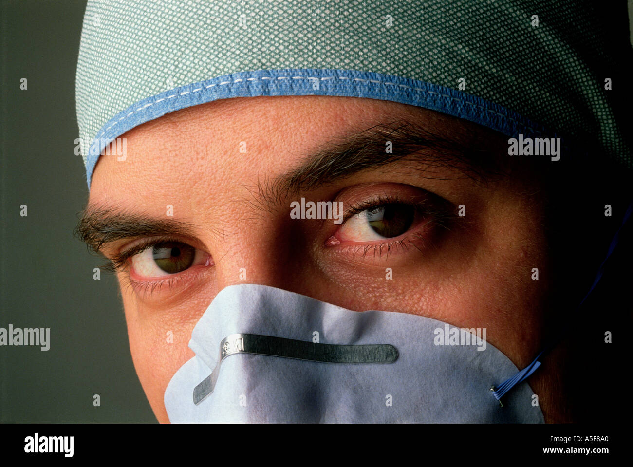 Close up view of surgeons face with surgical mask on Stock Photo - Alamy