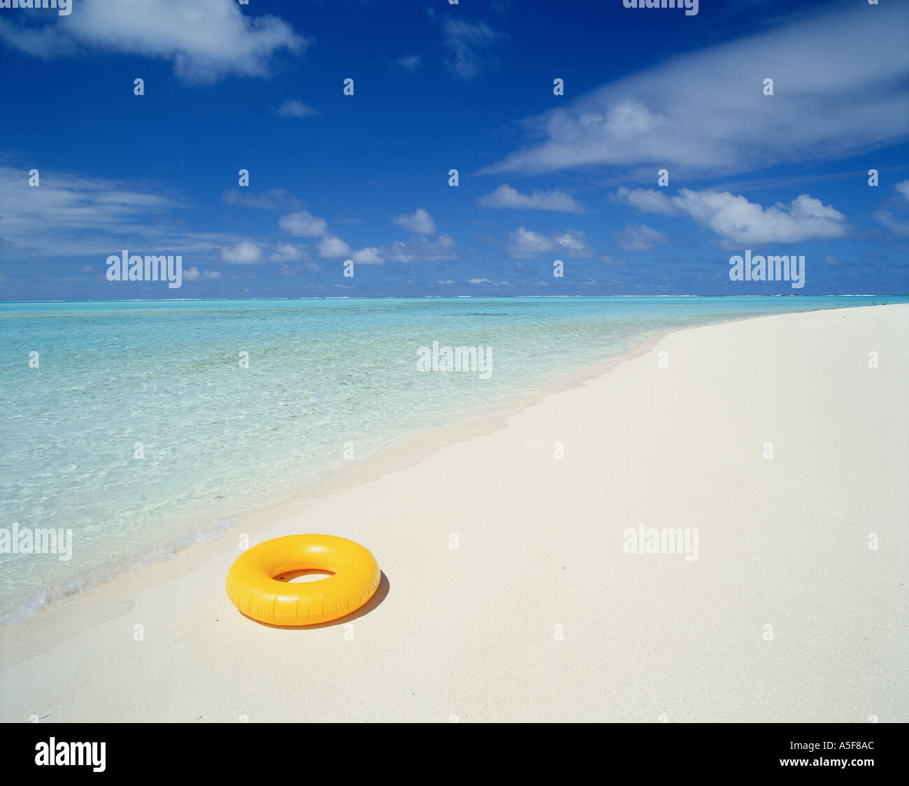 Yellow float ring on while tropical beach Stock Photo - Alamy