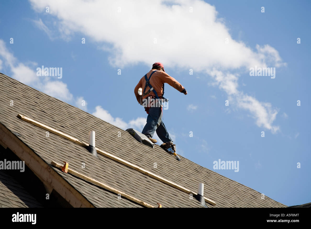Immigrant Worker Installing Roof Shingles Stock Photo - Alamy