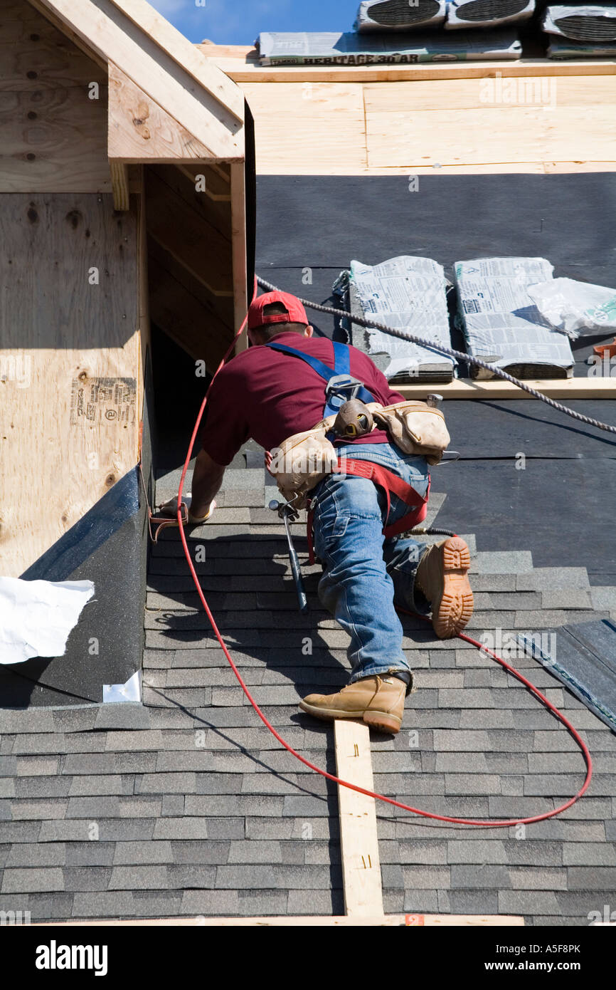 Immigrant Worker Installing Roof Shingles Stock Photo - Alamy