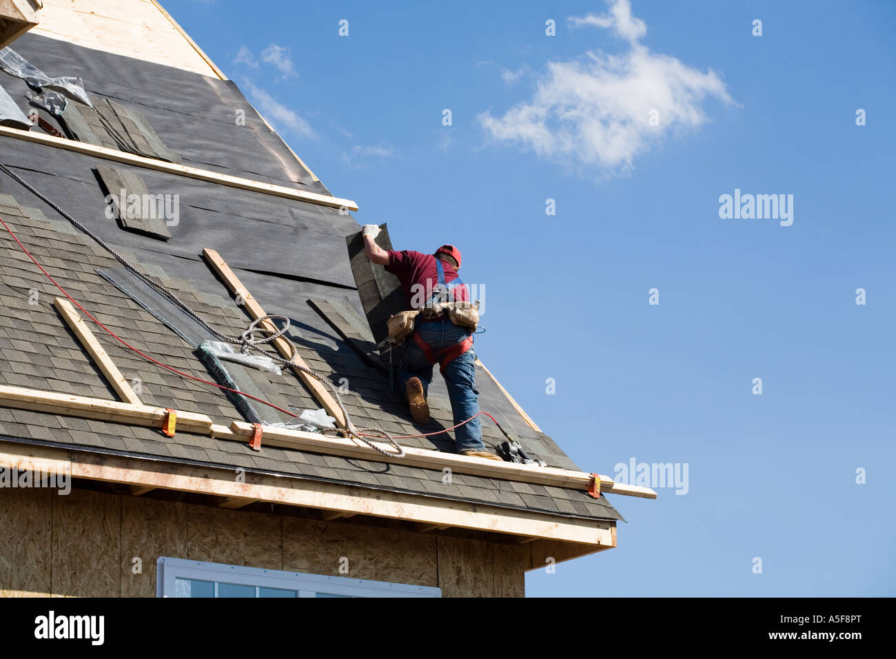 Immigrant Worker Installing Roof Shingles Stock Photo - Alamy