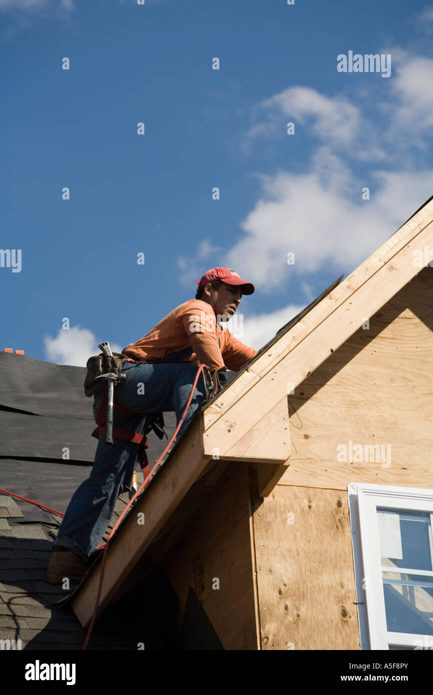Immigrant Worker Installing Roof Shingles Stock Photo - Alamy