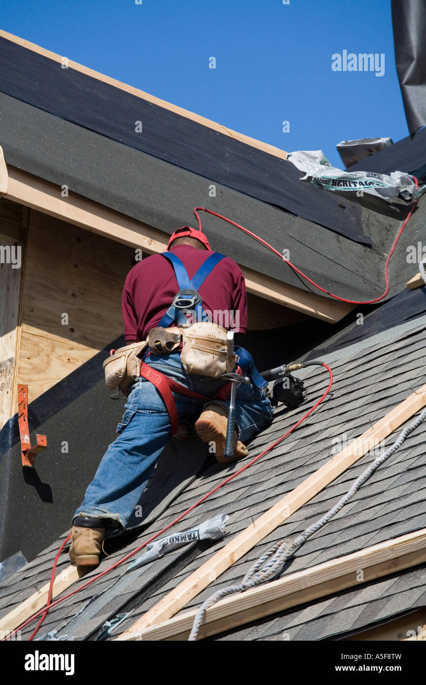 Immigrant Worker Installing Roof Shingle Stock Photo - Alamy