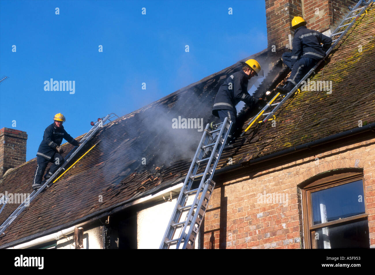 Firefighters at a house fire Stock Photo - Alamy