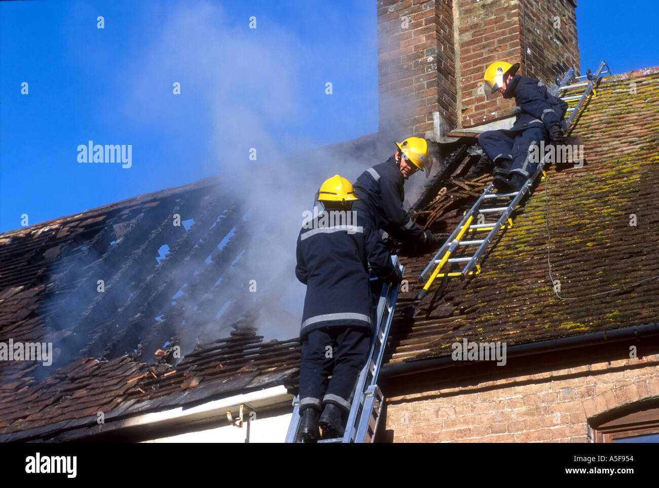 Firefighters at a house fire Stock Photo - Alamy